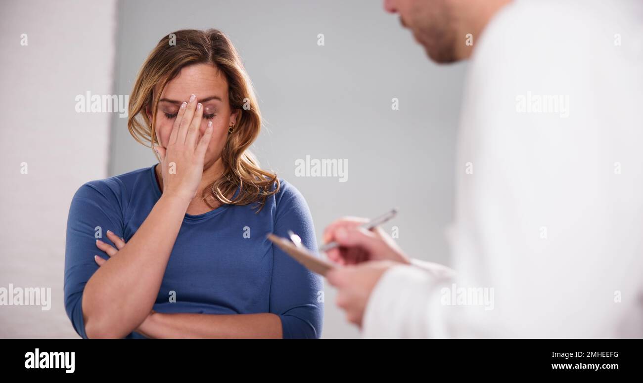 Female Patient With Headache In A Clinic Stock Photo - Alamy