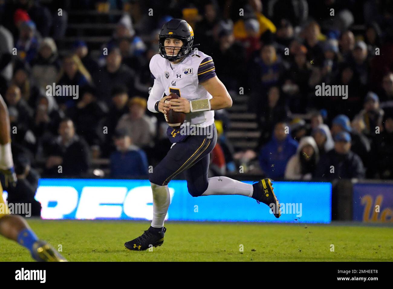 California quarterback Chase Garbers rolls out to pass during the first ...