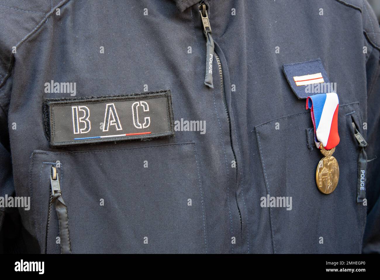 A medal hangs from the uniform of a policeman of the BAC (Anti ...