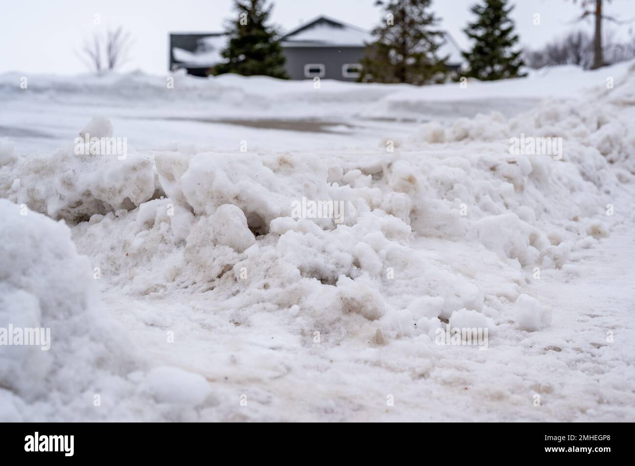 Snowbank at the end of a driveway left after city snowplows cleared a ...
