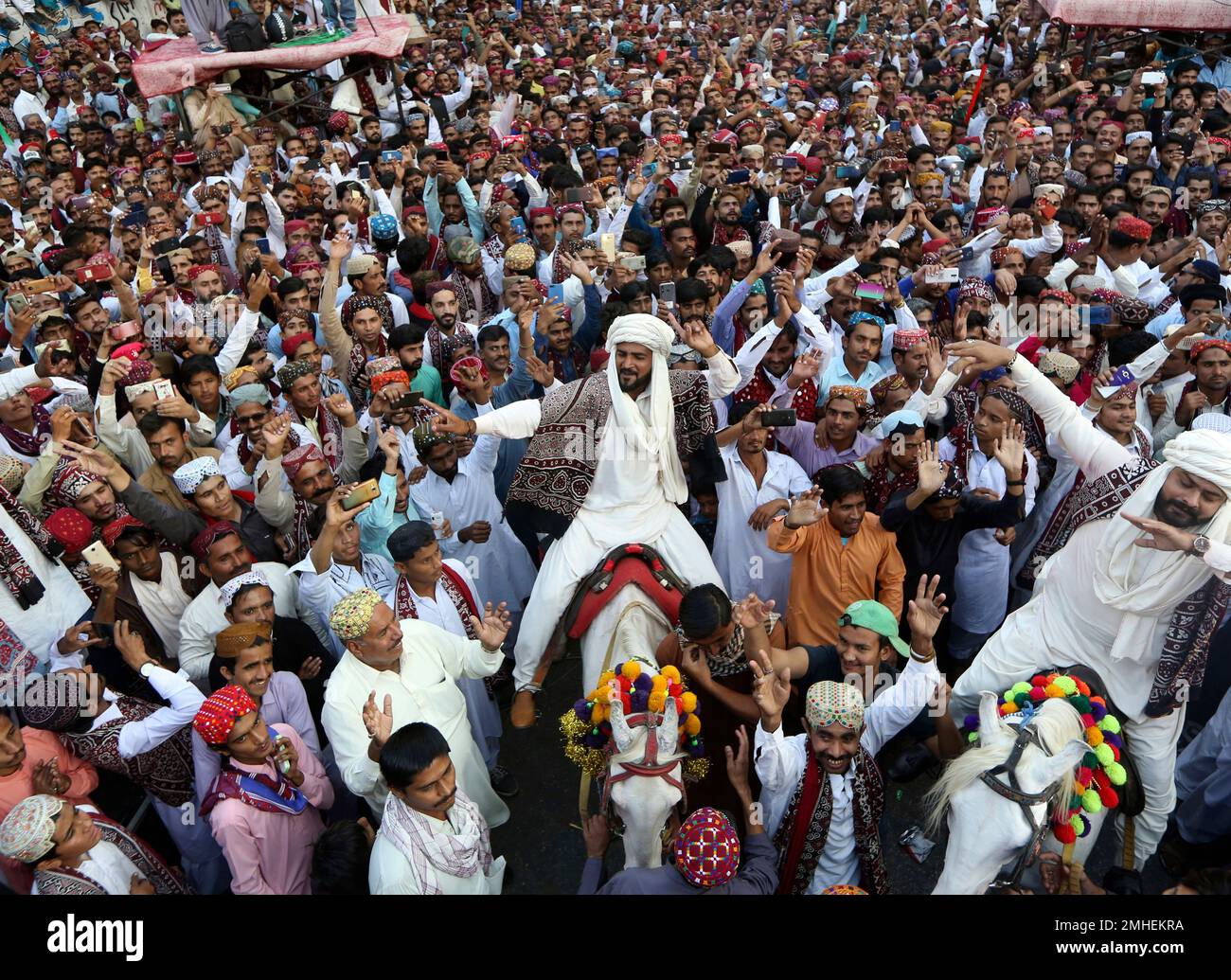 People in traditional dress dance during a rally to celebrate the Sindh ...