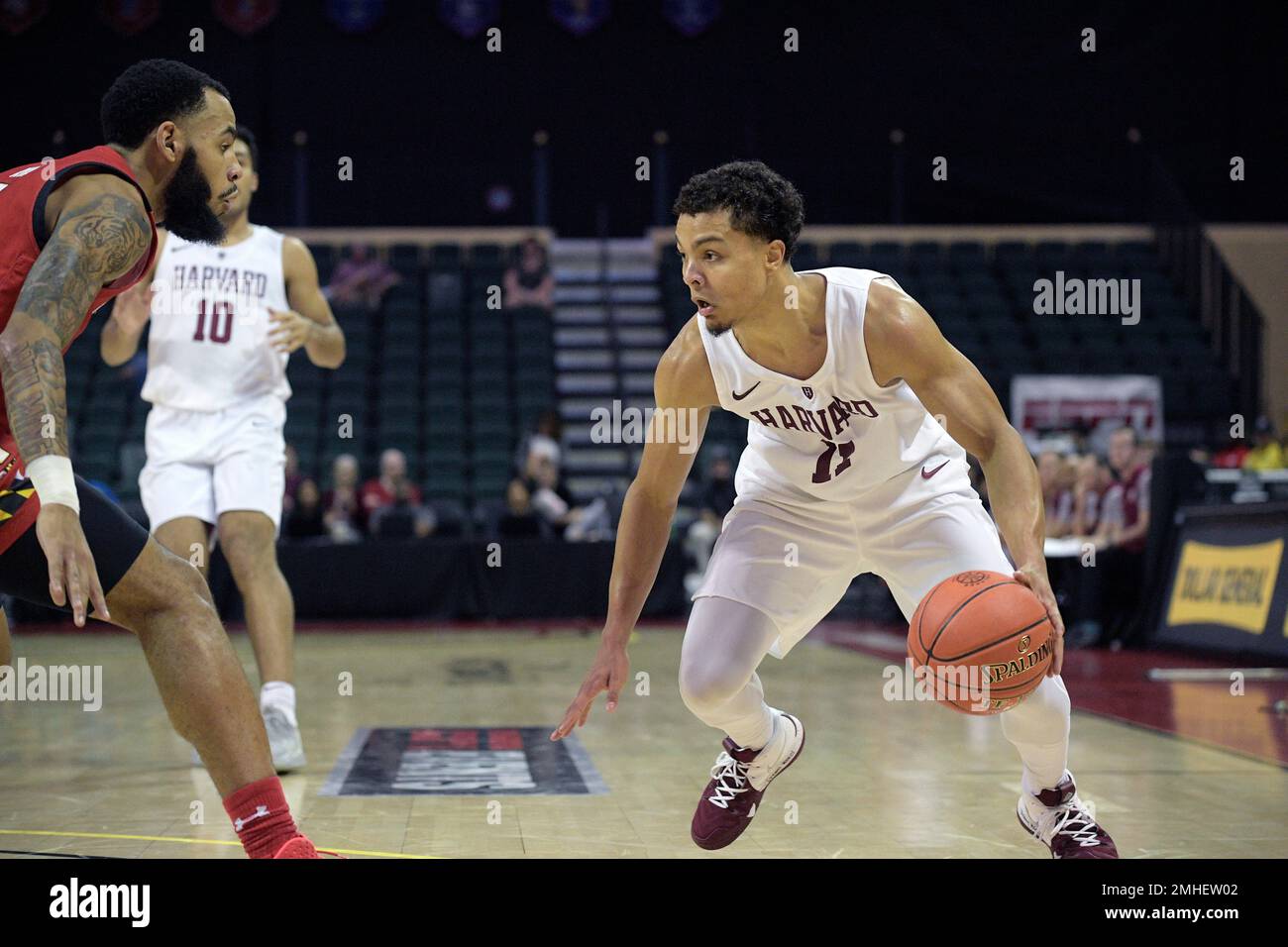 Harvard guard Bryce Aiken (11) sets up in front of Maryland guard Eric ...