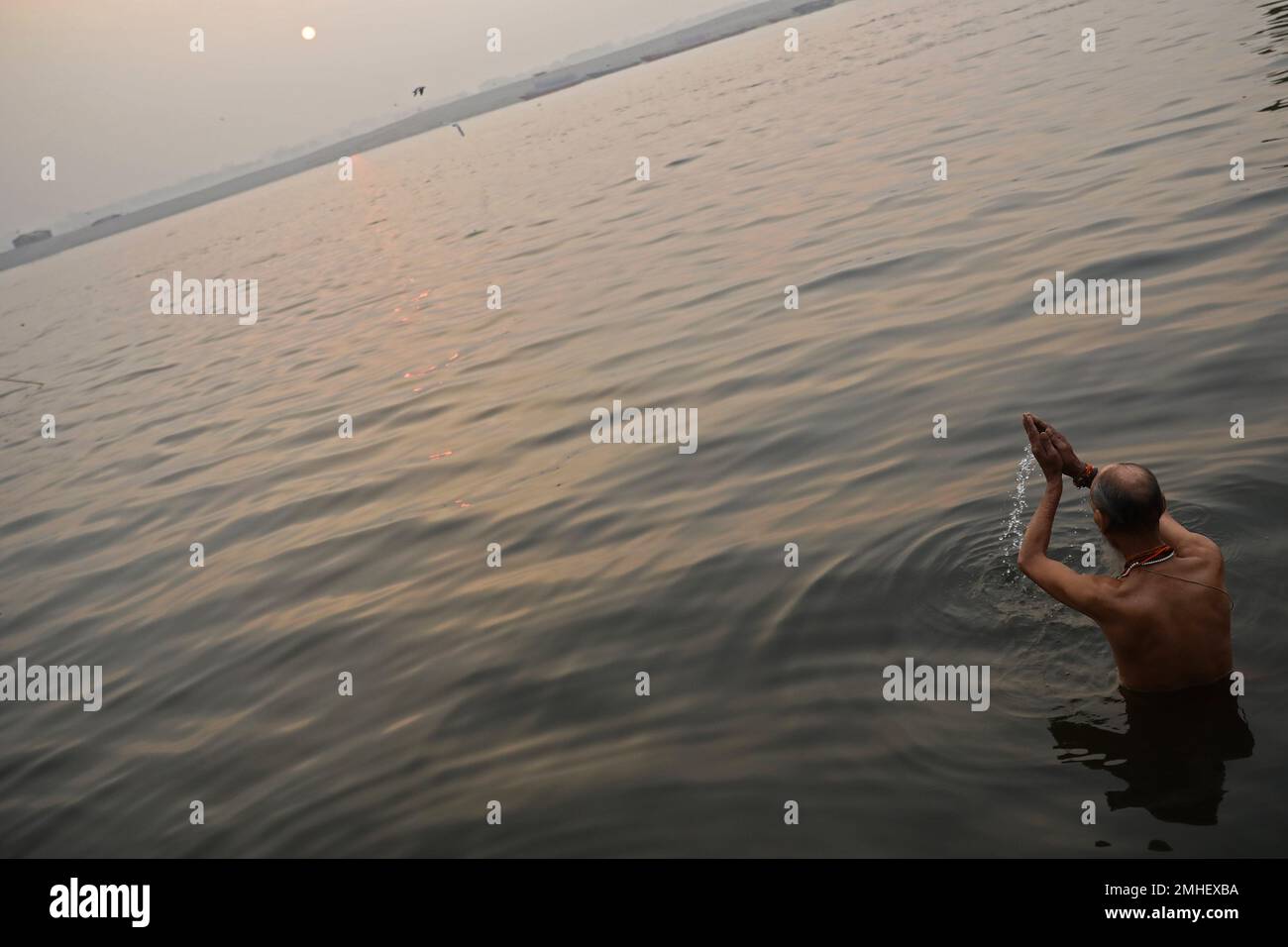 Varanasi, India. 26th Jan, 2023. A man prays while standing in river ...