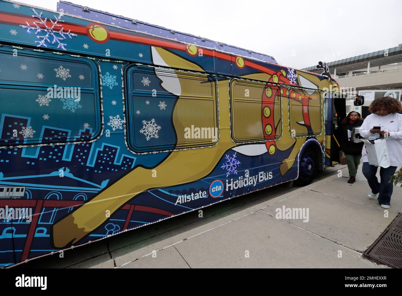 This photo shows an exterior view of a CTA Holiday bus at a bus stop in ...