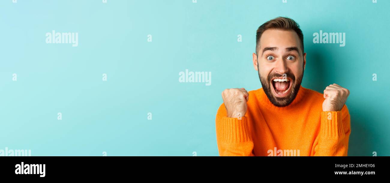 Image of handsome relieved man feeling satisfaction, rejoicing of ...