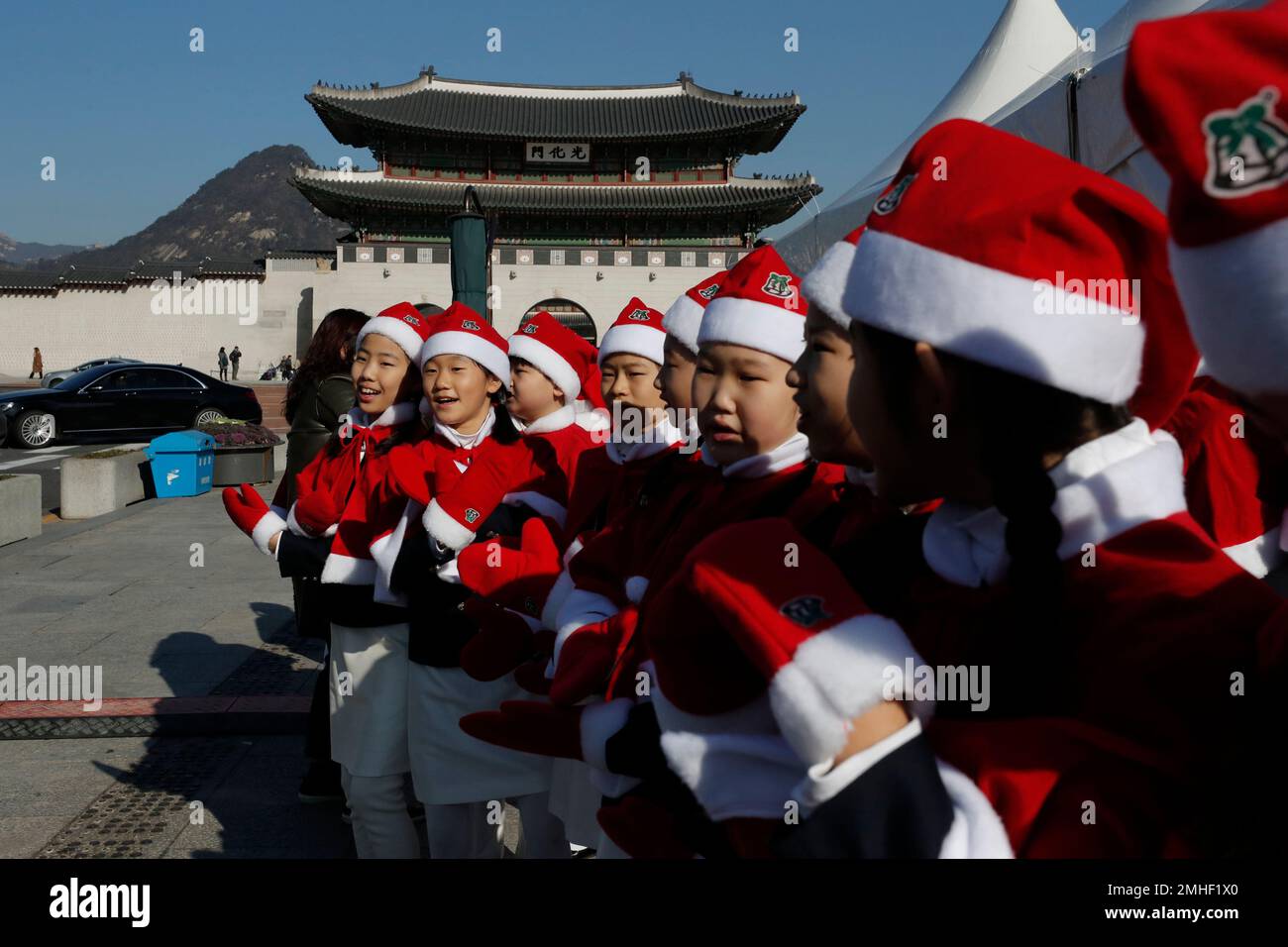 South Korean children in Santa Claus outfits wait to attend a ceremony ...