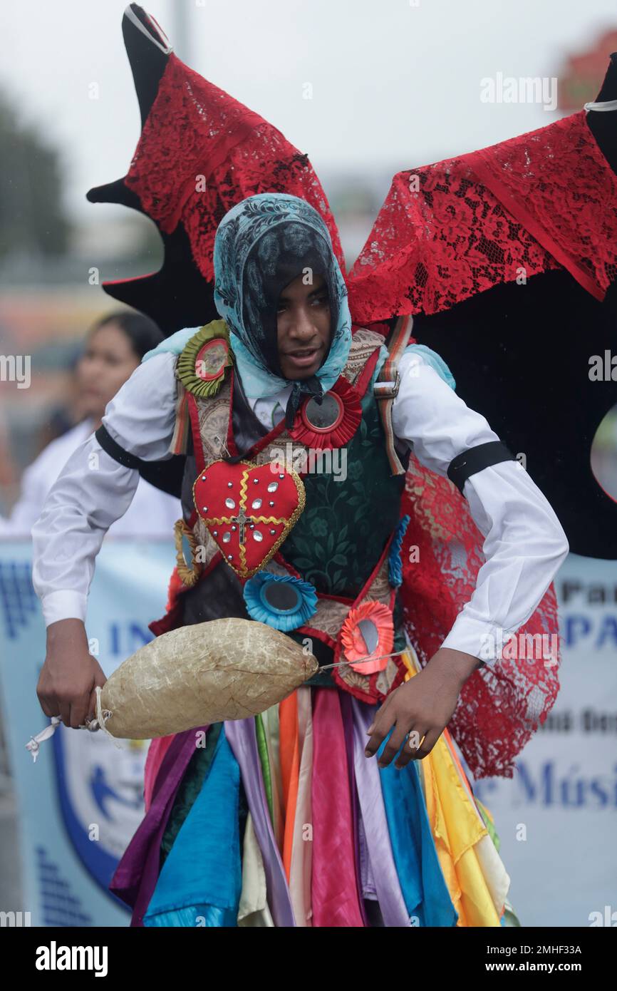 A student wearing a devil costume take part in an independence day ...
