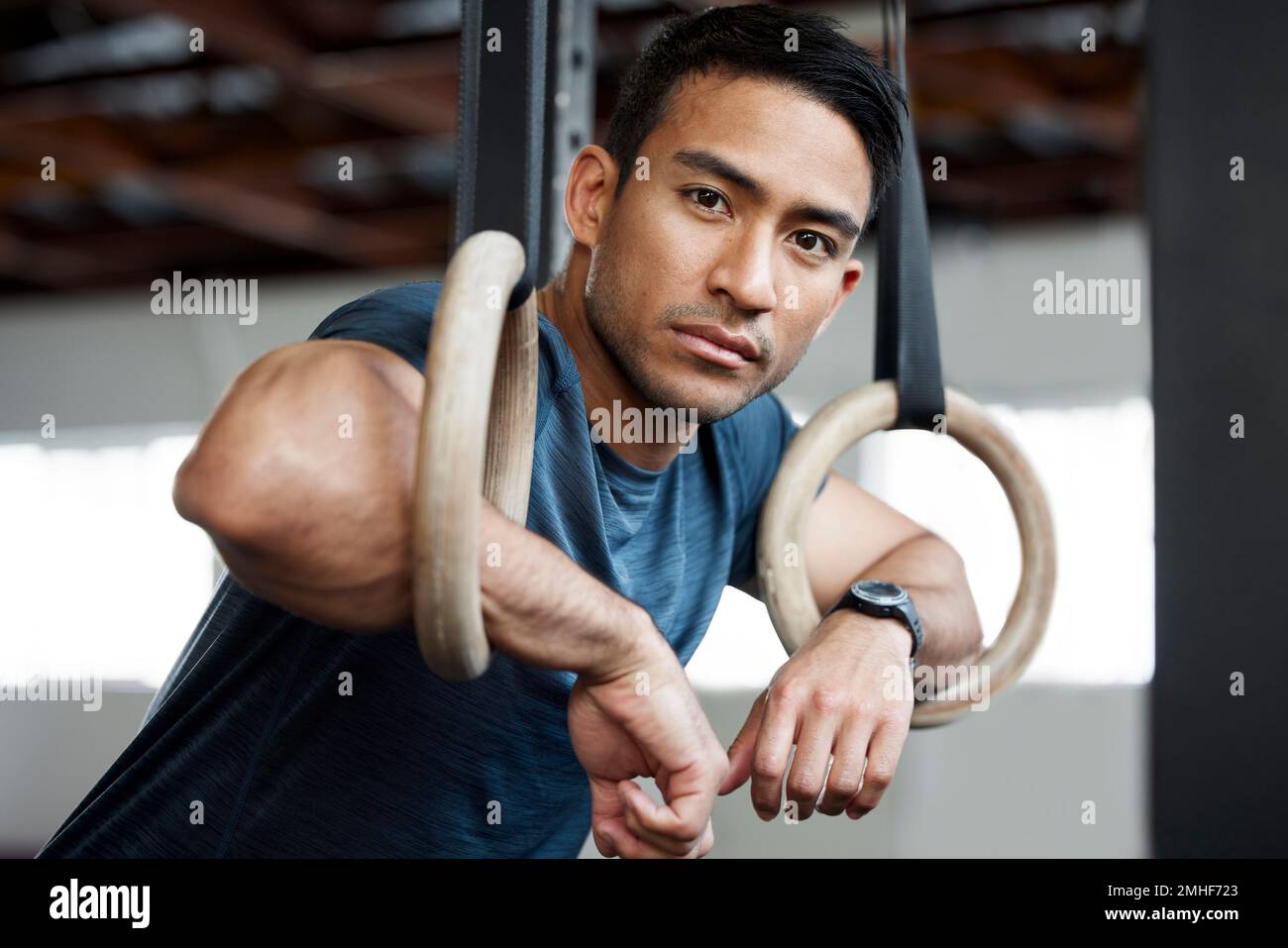 Portrait, gymnastic rings and olympics with a man gymnast hanging on ...