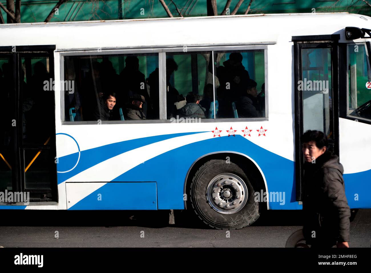 A man looks out of the window from inside a trolleybus in Pyongyang ...