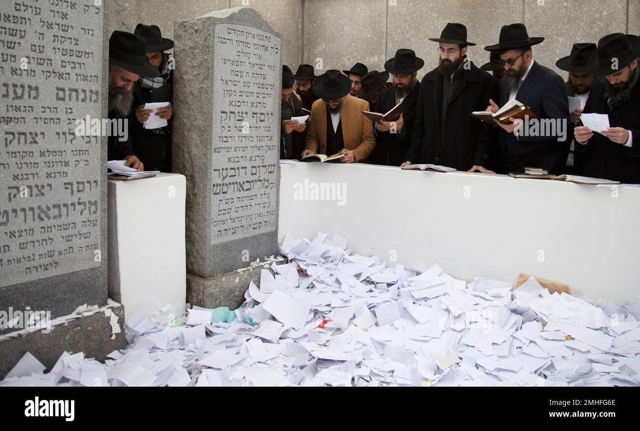In this Nov. 22, 2019, photo, Hasidic leaders read personal notes and ...