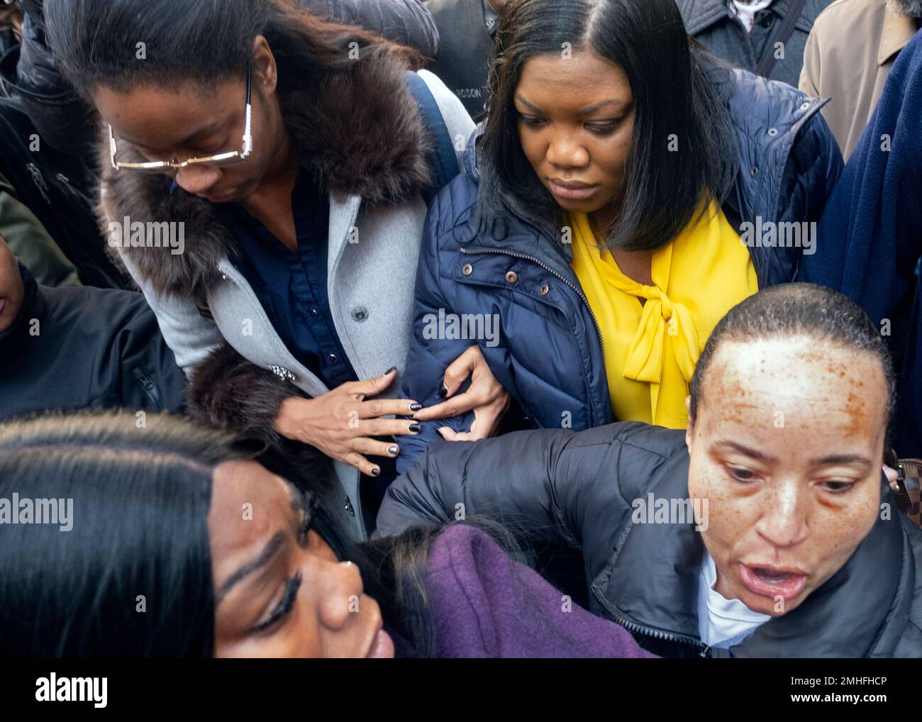 Tova Noel, center right in yellow blouse, a federal jail guard ...