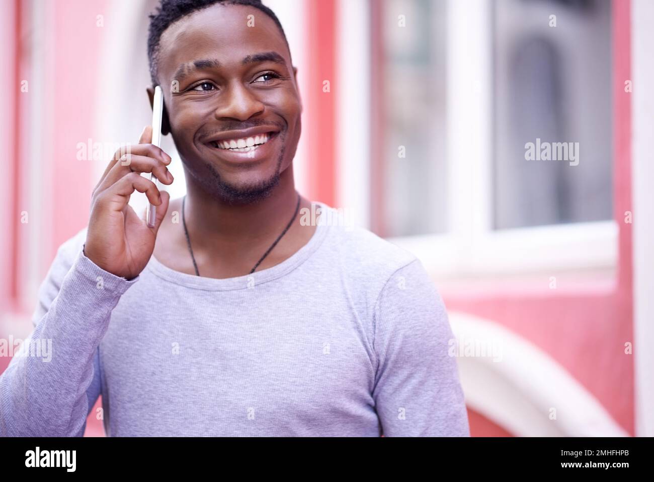 Sure, Ill wait for you. a young man using his phone while out in the ...