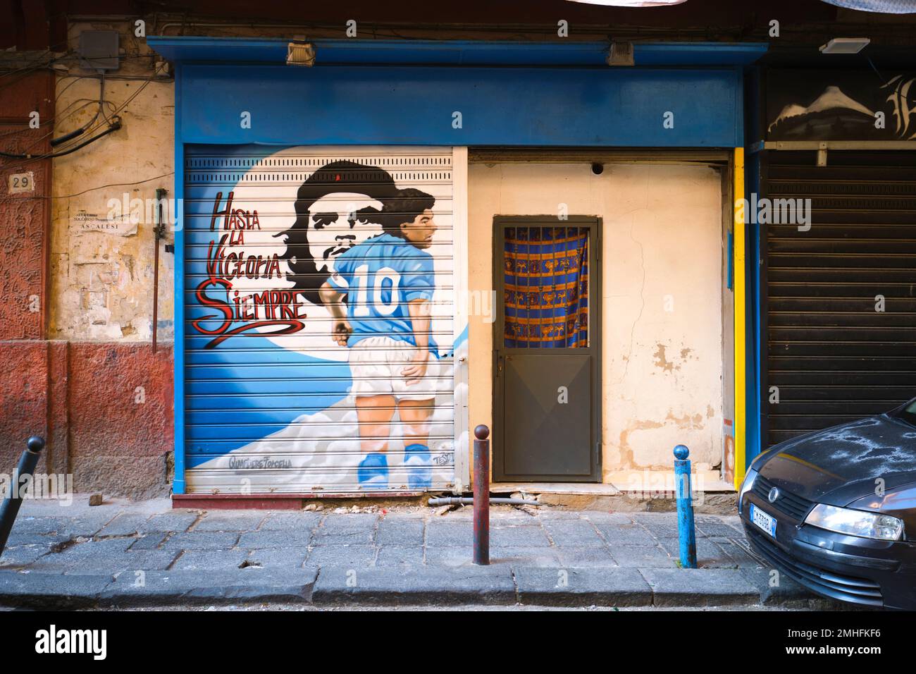 A storefront mural of footballer, soccer star Diego Maradona with Cuban ...