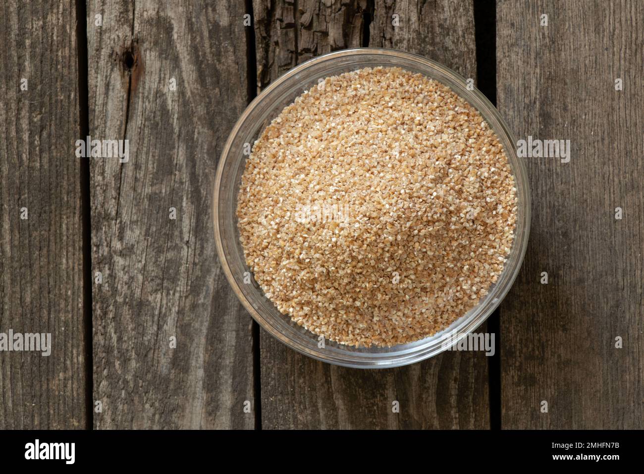 raw wheat groats in a plate stands on an table Stock Photo - Alamy