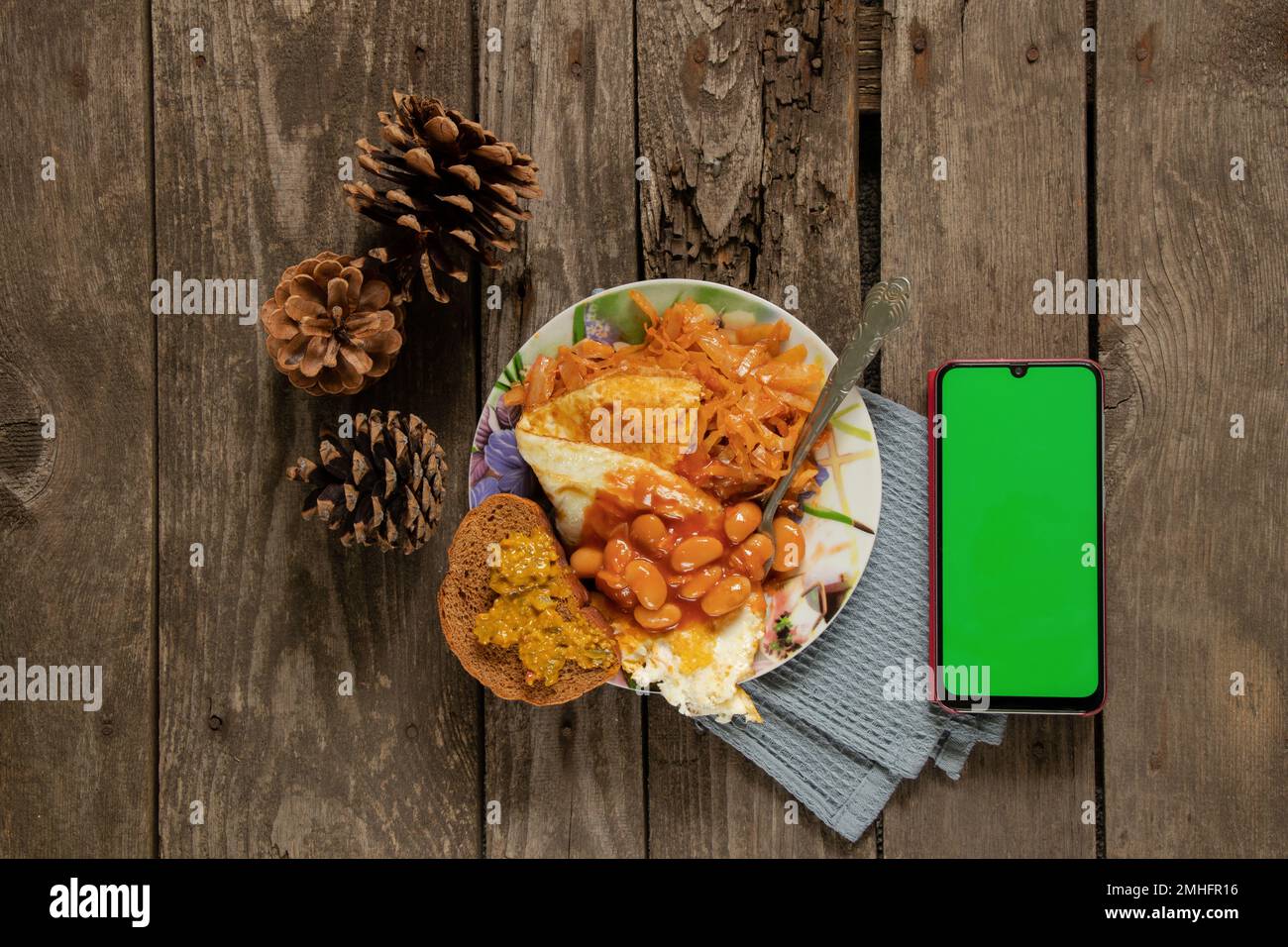 lunch plate with fried egg and salad and a phone with a green screen ...