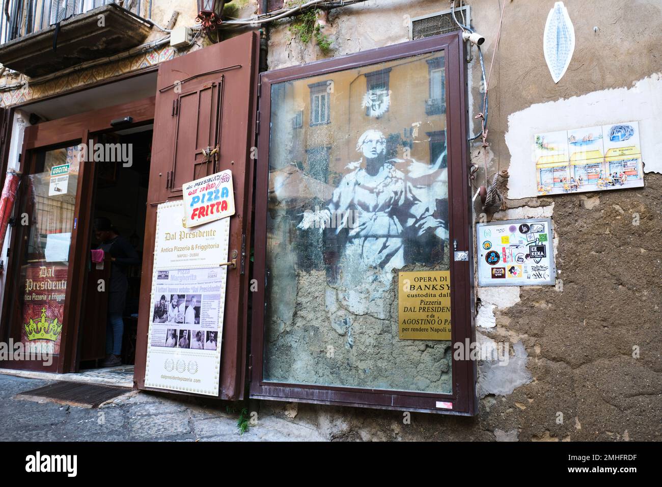 A Banksy, Madonna with a Pistol, now protected under glass. An example ...