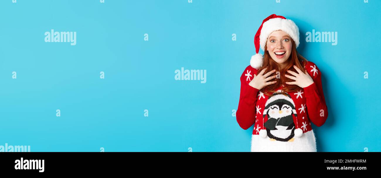 Happy holidays and Christmas concept. Surprised redhead girl receiving ...