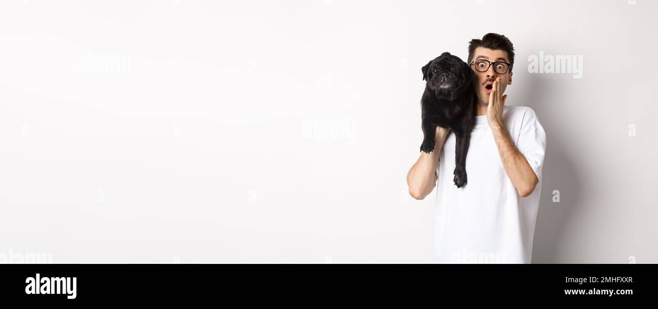 Image of shocked dog owner staring at camera and gasping impressed ...