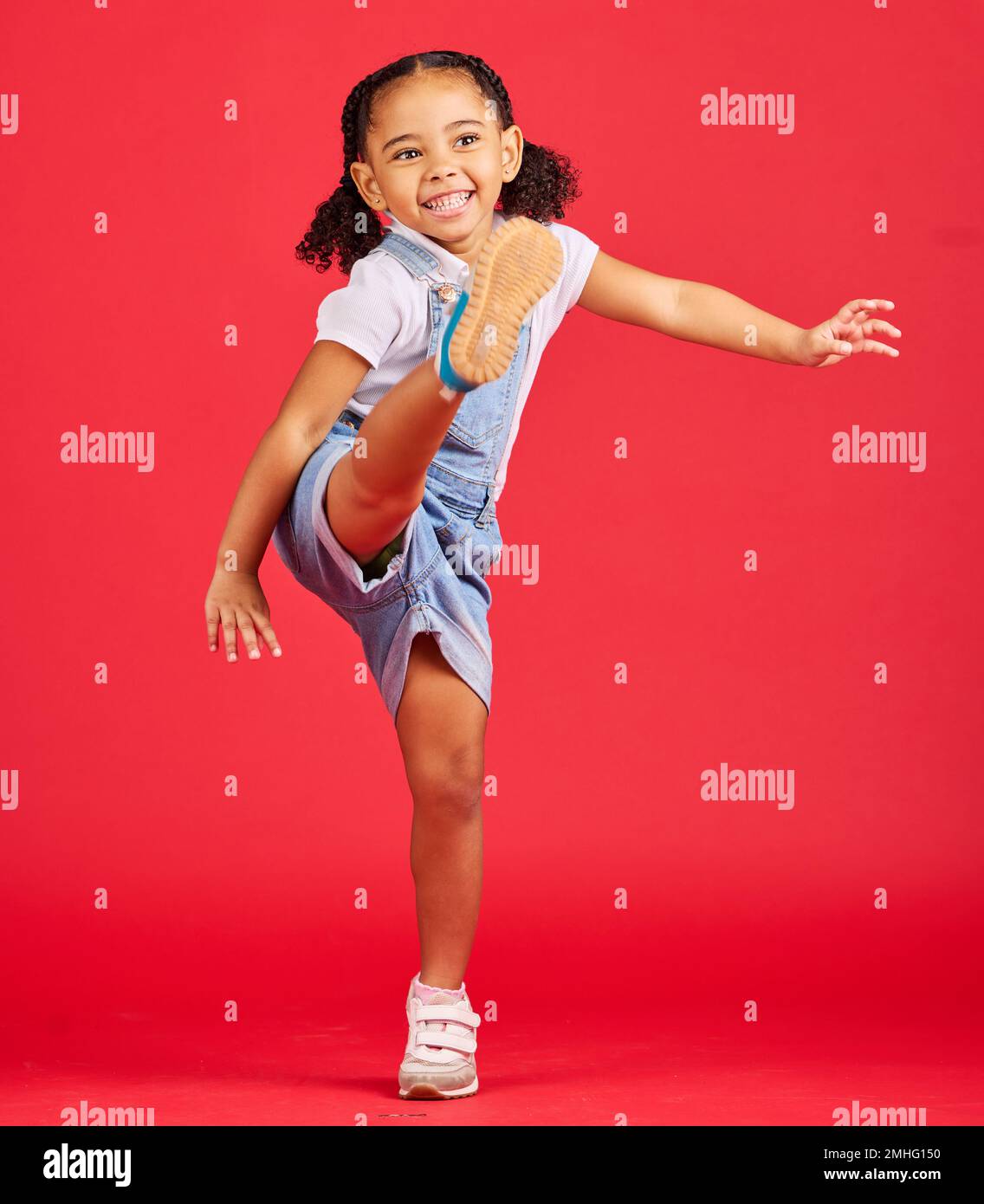 Happy, kick and excited girl in a studio with a casual, stylish and ...