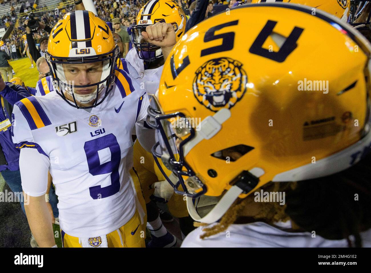 LSU quarterback Joe Burrow (9) huddles up on the field against Arkansas ...