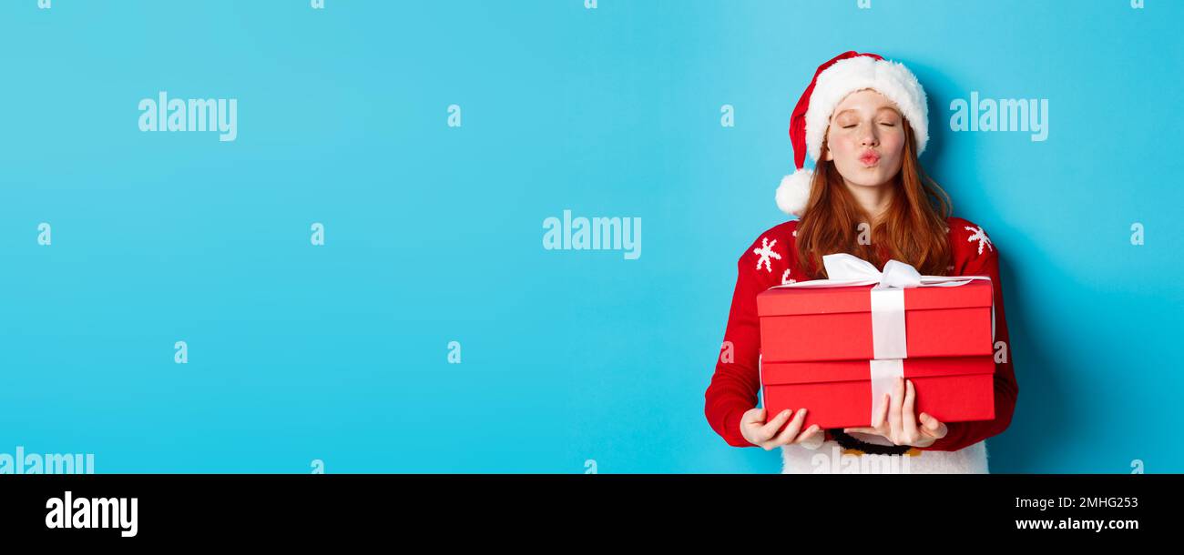 Happy holidays and Christmas concept. Cute redhead girl holding ...