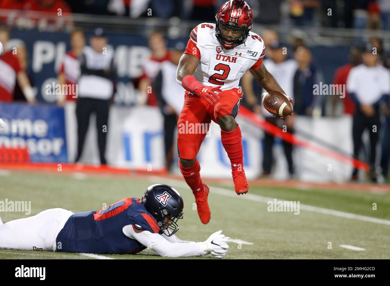 Utah running back Zack Moss (2) avoids the tackle attempt by Arizona ...