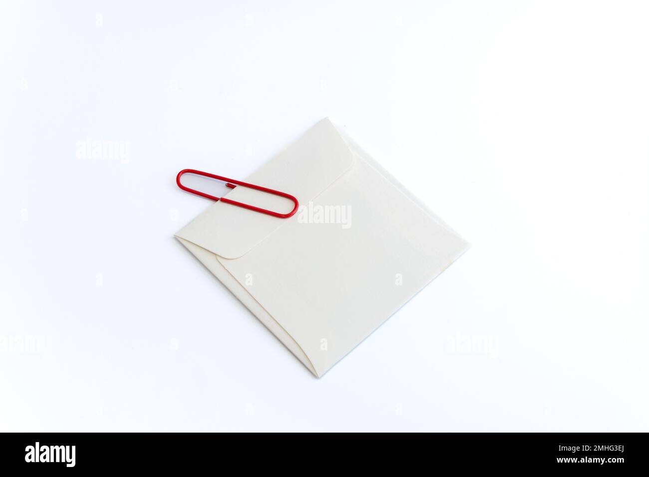 White envelope and Red Clip on white background with Clipping Path. Announcement, bulletin ...