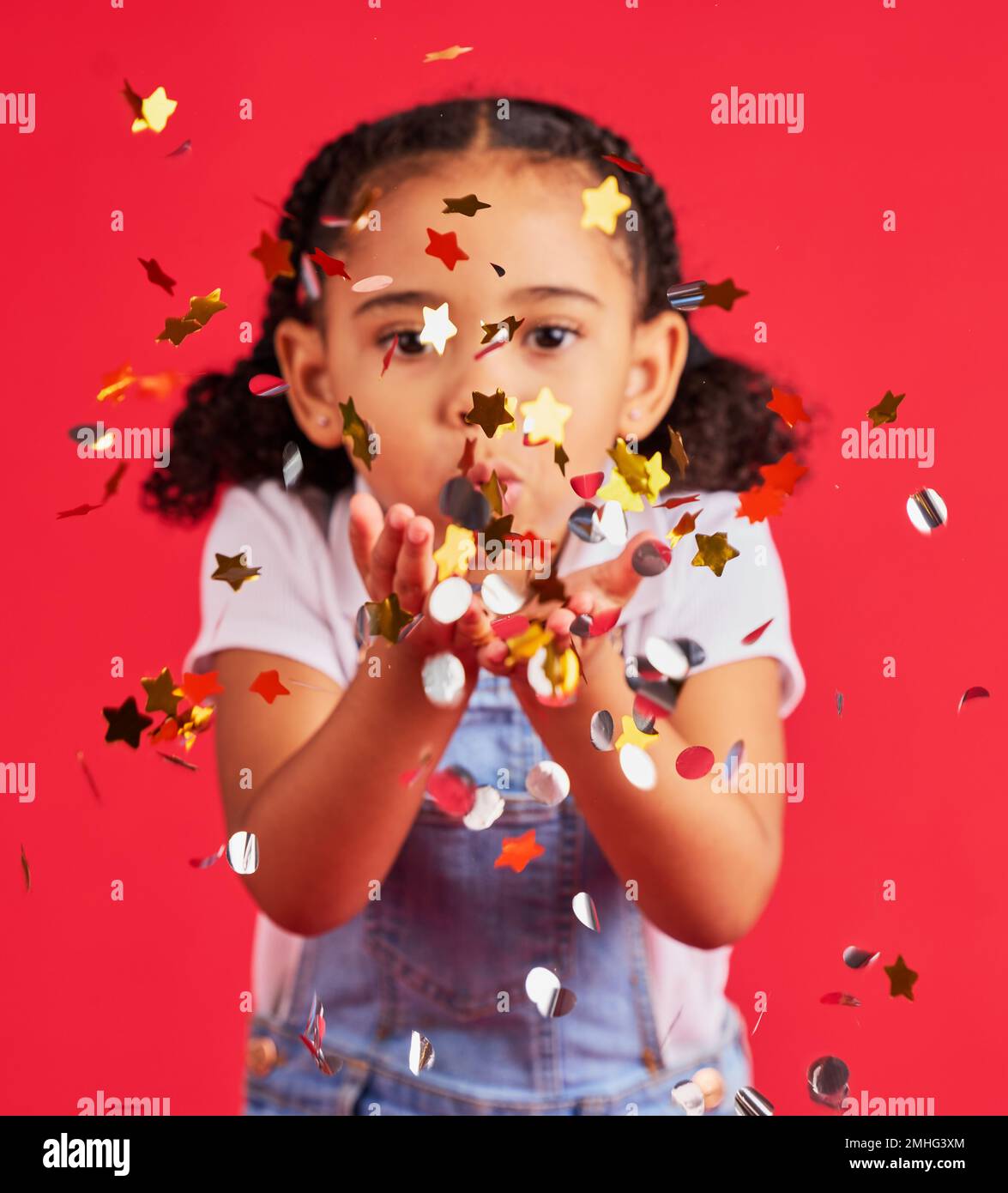 Young girl, kid blowing confetti with party and celebration, gold and ...