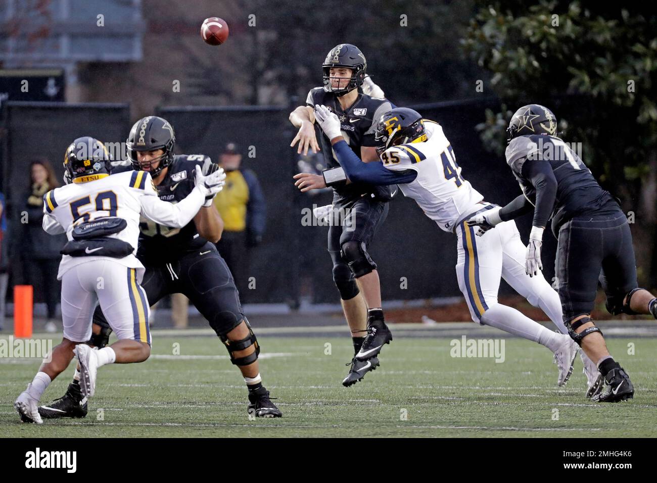 Vanderbilt quarterback Riley Neal throws as he is hit by ETSU defensive ...