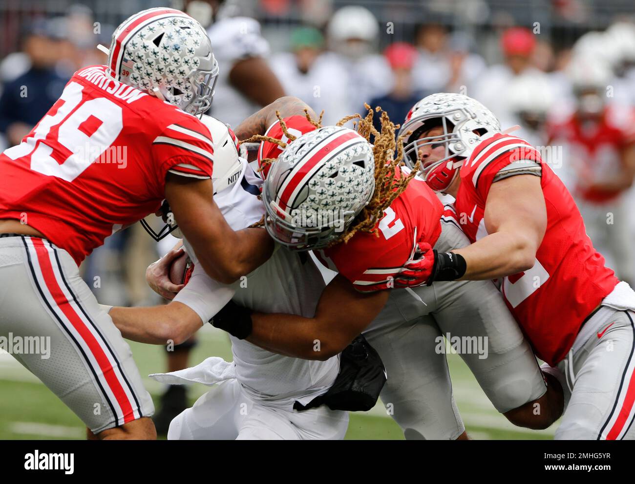 Ohio State defenders, left to right, Malik Harrison, Chase Young and ...