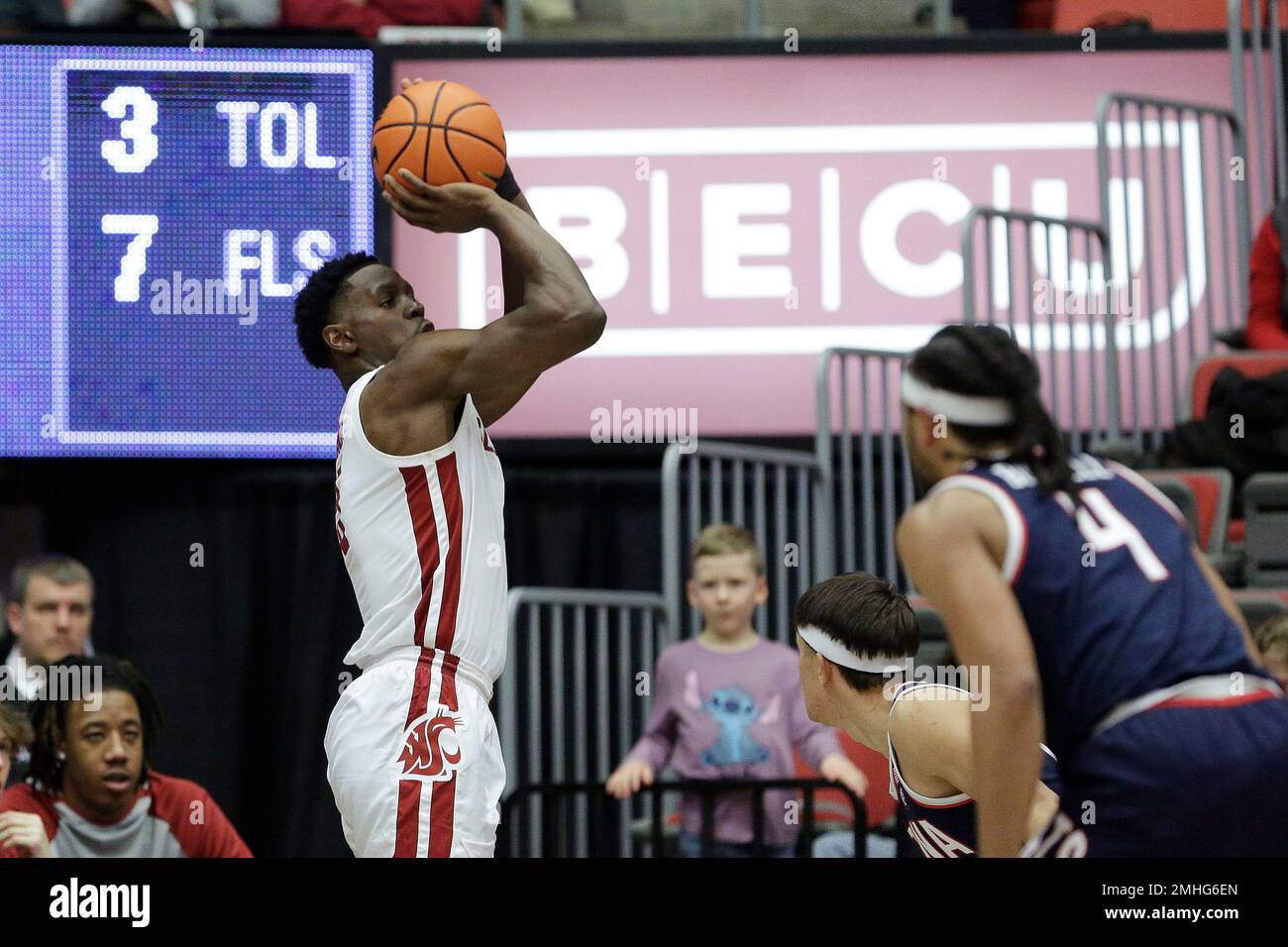 Washington State guard TJ Bamba shoots while defended by Arizona guard ...