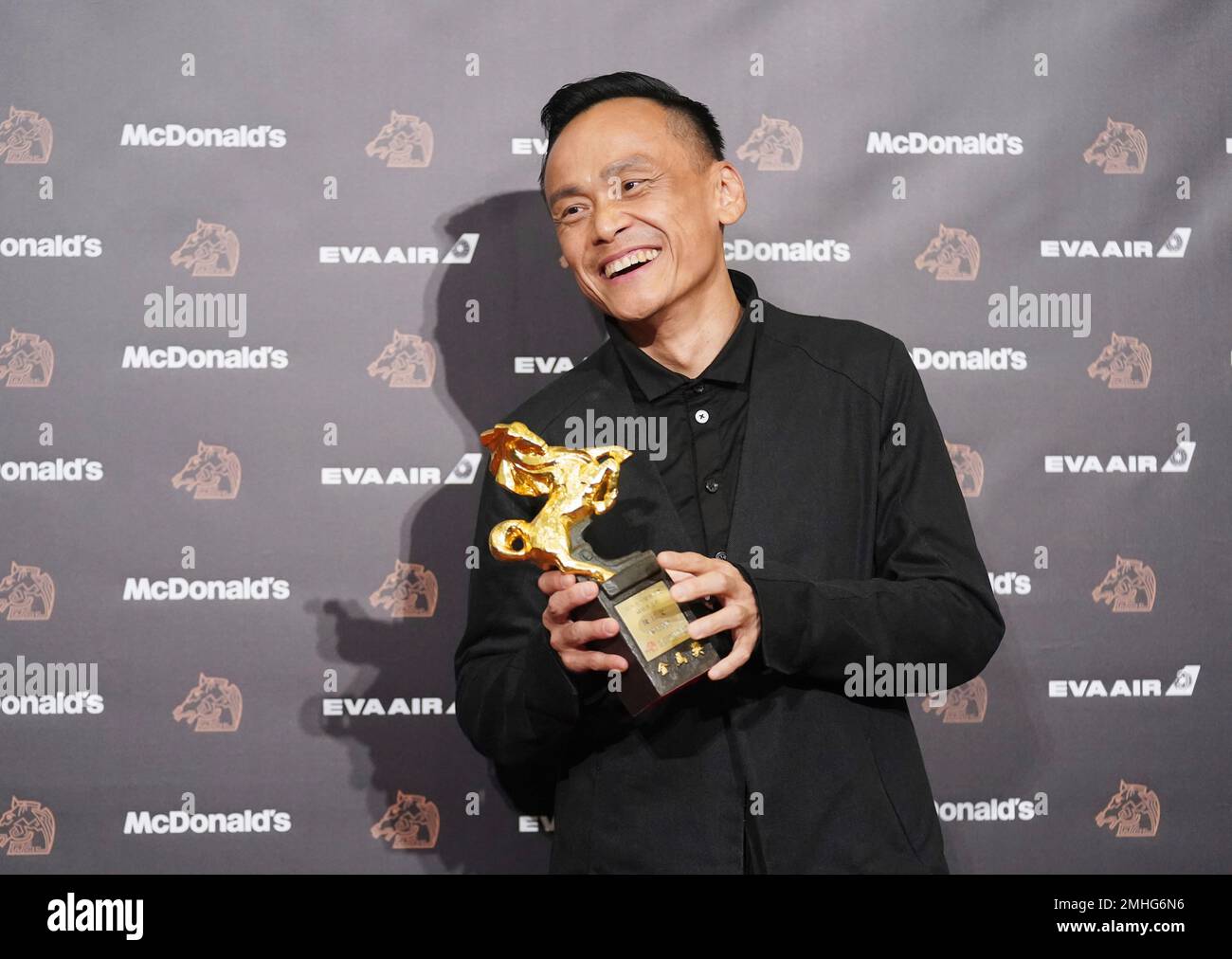 Taiwanese actor Chen Yi-wen holds his award for Best Leading Actor at ...