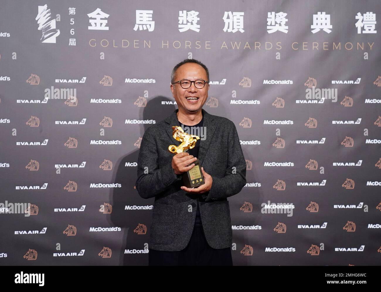 Taiwanese director Chung Mong-hong holds his award for Best Director at ...