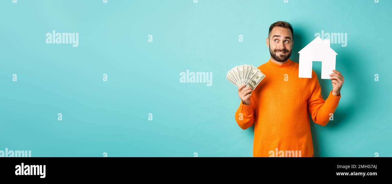 Real estate concept and mortgage concept. Handsome young man buying ...