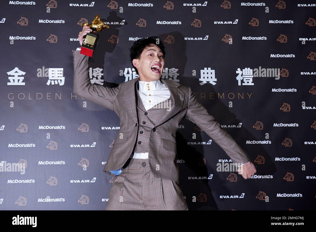 Taiwanese actor Fandy Fan holds his award for Best New Performer at the ...