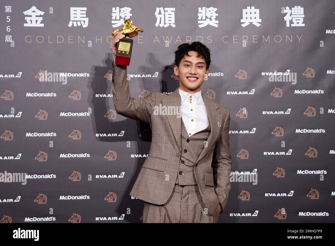 Taiwanese actor Fandy Fan holds his award for Best New Performer at the ...