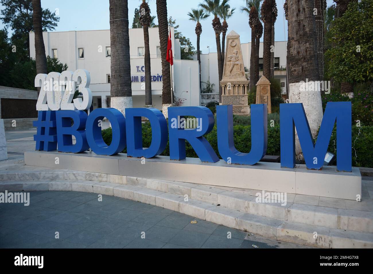 Large Blue 'BODRUM' Sign in Outdoor Public Space with Palm Trees Stock ...