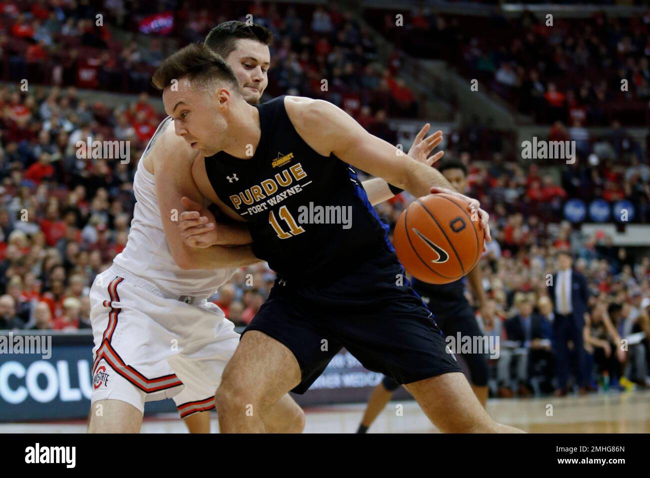 Purdue Fort Wayne forward Dylan Carl, left, drives in front of Ohio ...