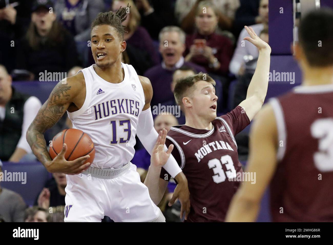 Washington's Hameir Wright (13) grabs a rebound next to Montana's Jared ...