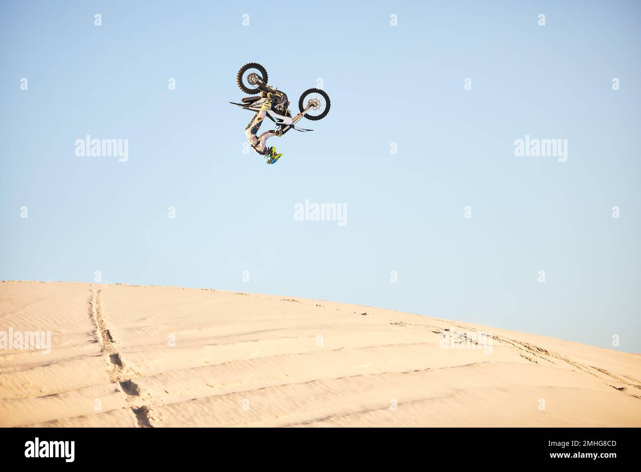 Motorcycle, jump and sports athlete in desert, dirt bike rally outdoor ...