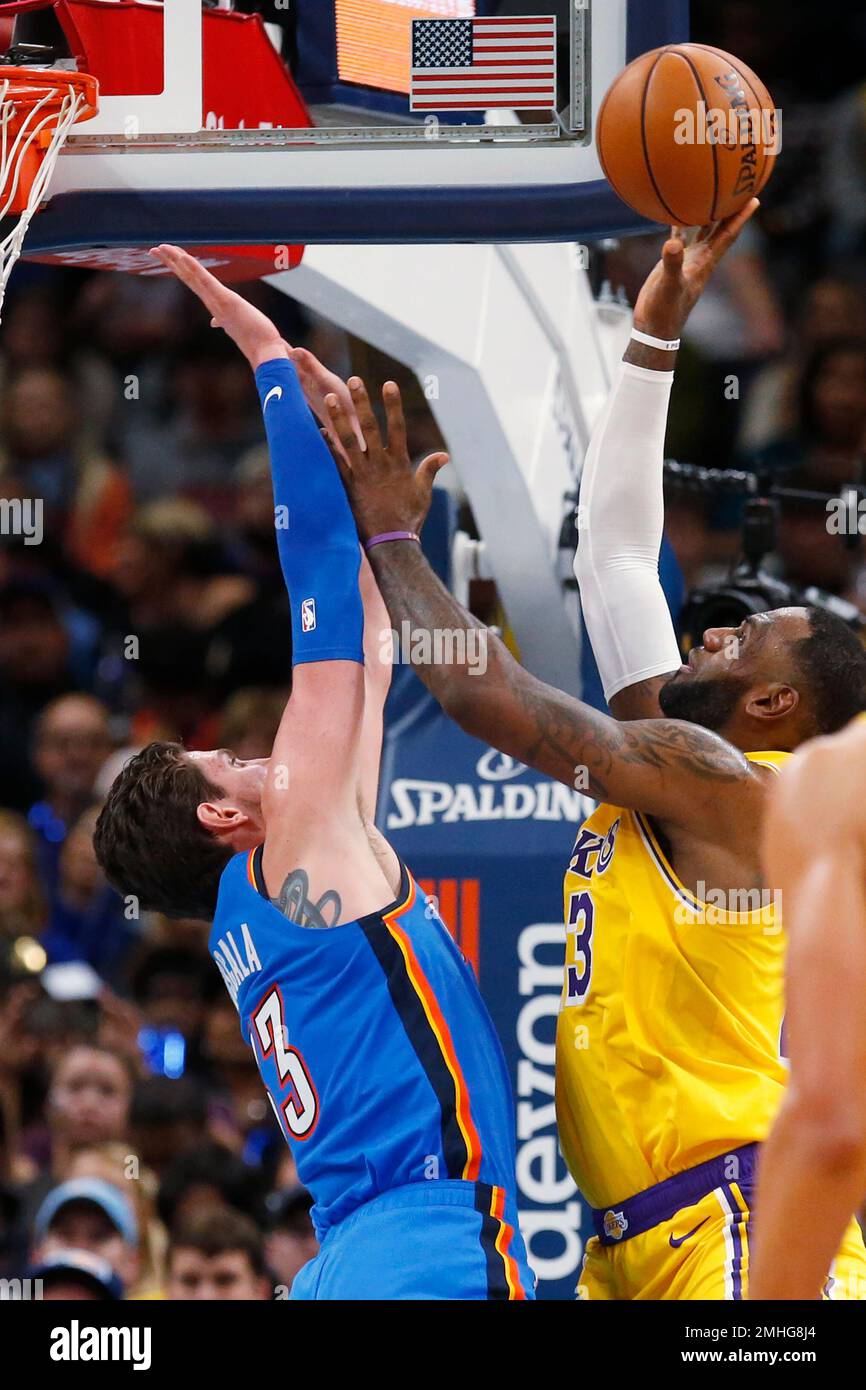 Los Angeles Lakers forward LeBron James, right, shoots as Oklahoma City ...