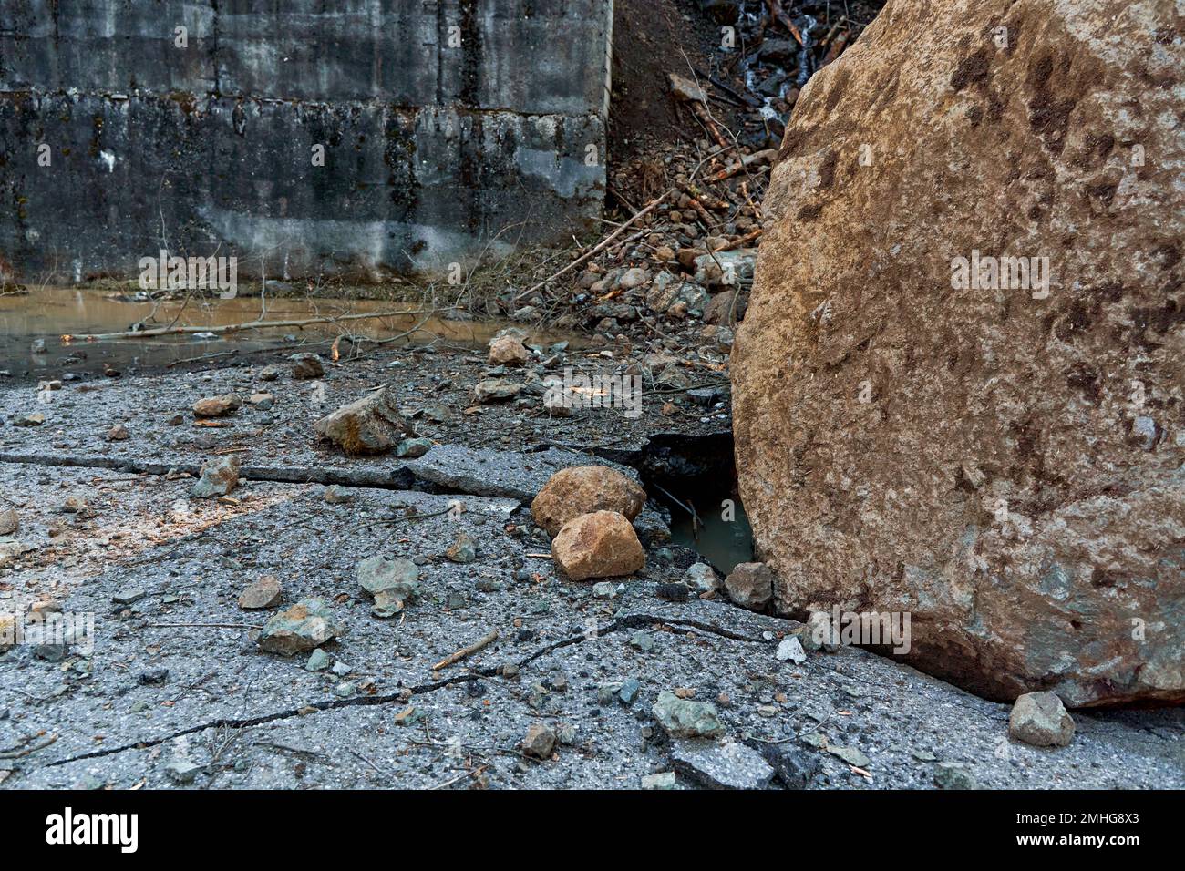 A huge rock fell from the mountains onto the road, destroying the ...