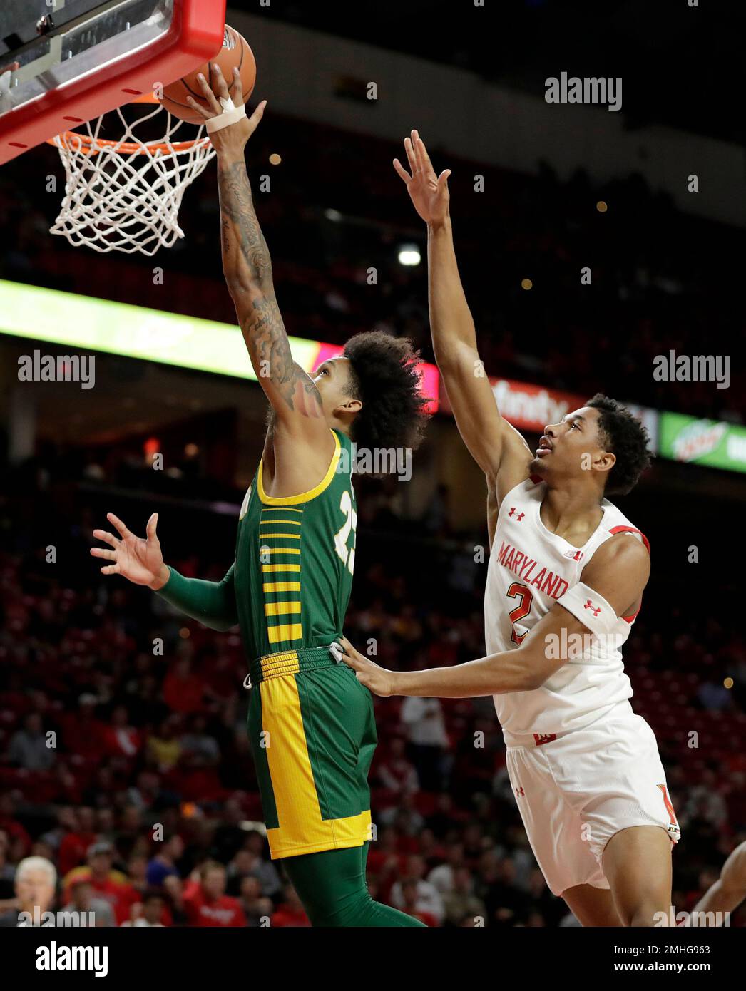 George Mason guard Javon Greene, left, goes up for a shot against ...