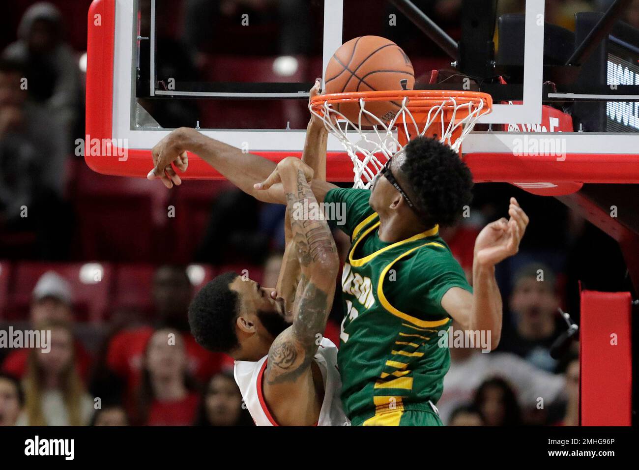 Maryland guard Eric Ayala, left, dunks on George Mason forward AJ ...