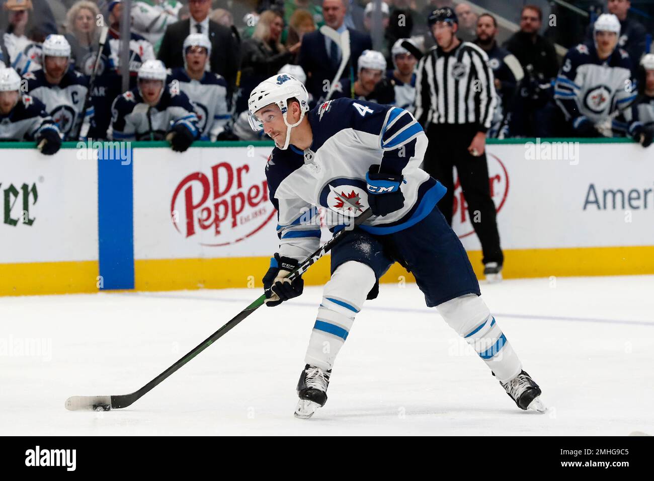 Winnipeg Jets defenseman Neal Pionk (4) takes a shot during an NHL ...