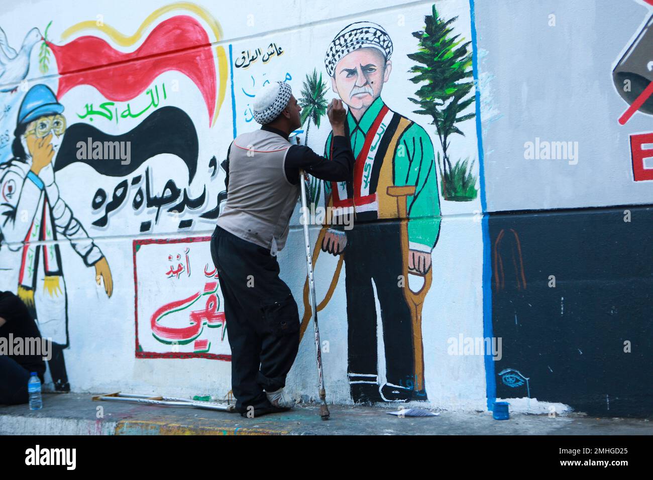 In this Sunday, Nov. 17, 2019 photo, a protestor adds some details and ...