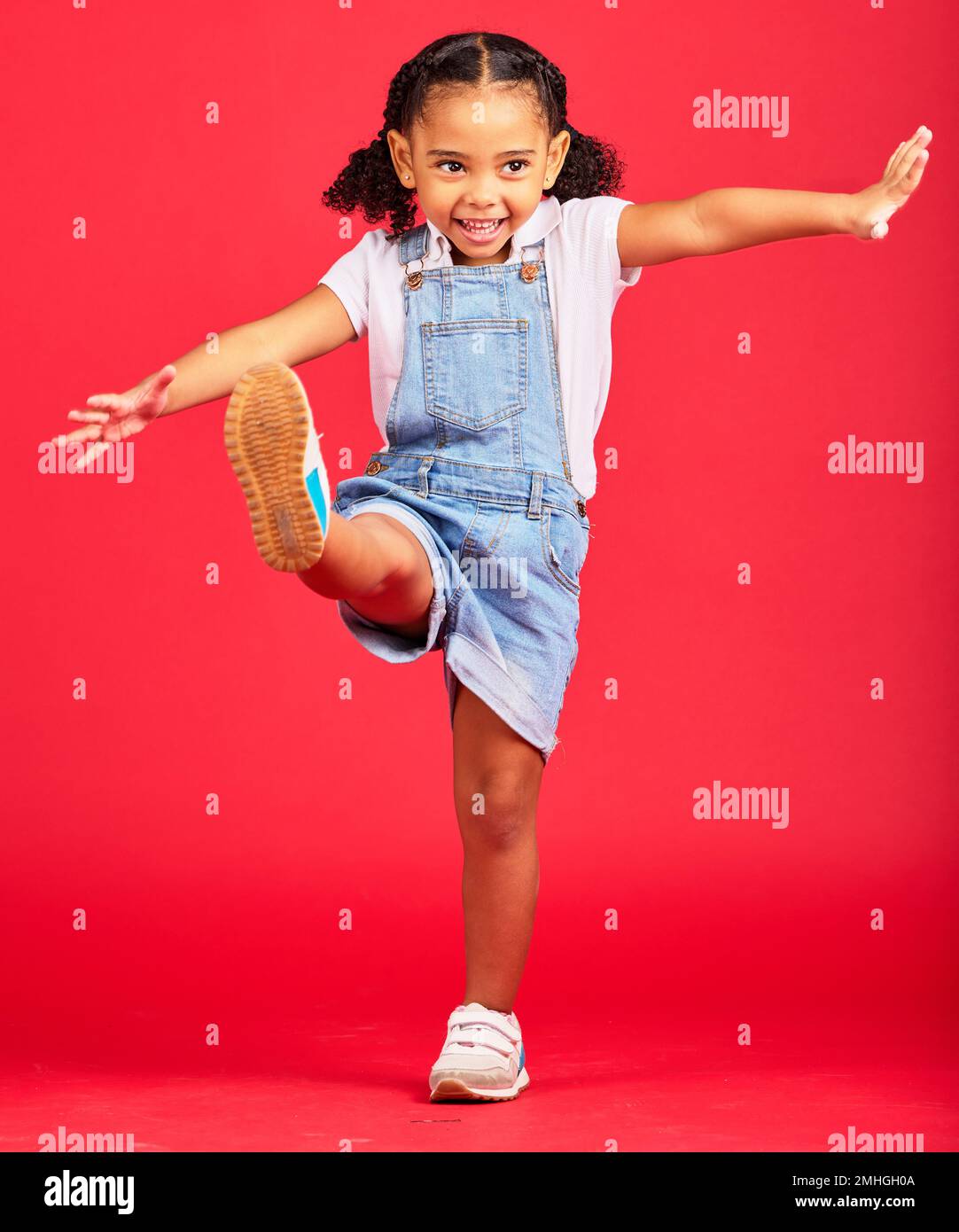 Happy, youth and girl on red background kick legs for happy childhood ...