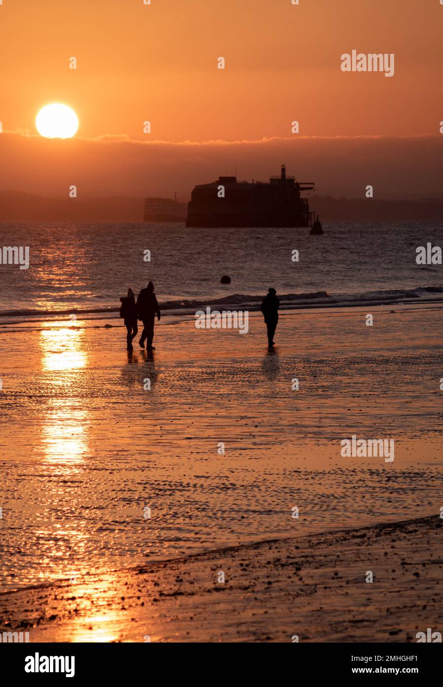 Looking across the Solent at the sun setting over Spitbank fort and the ...