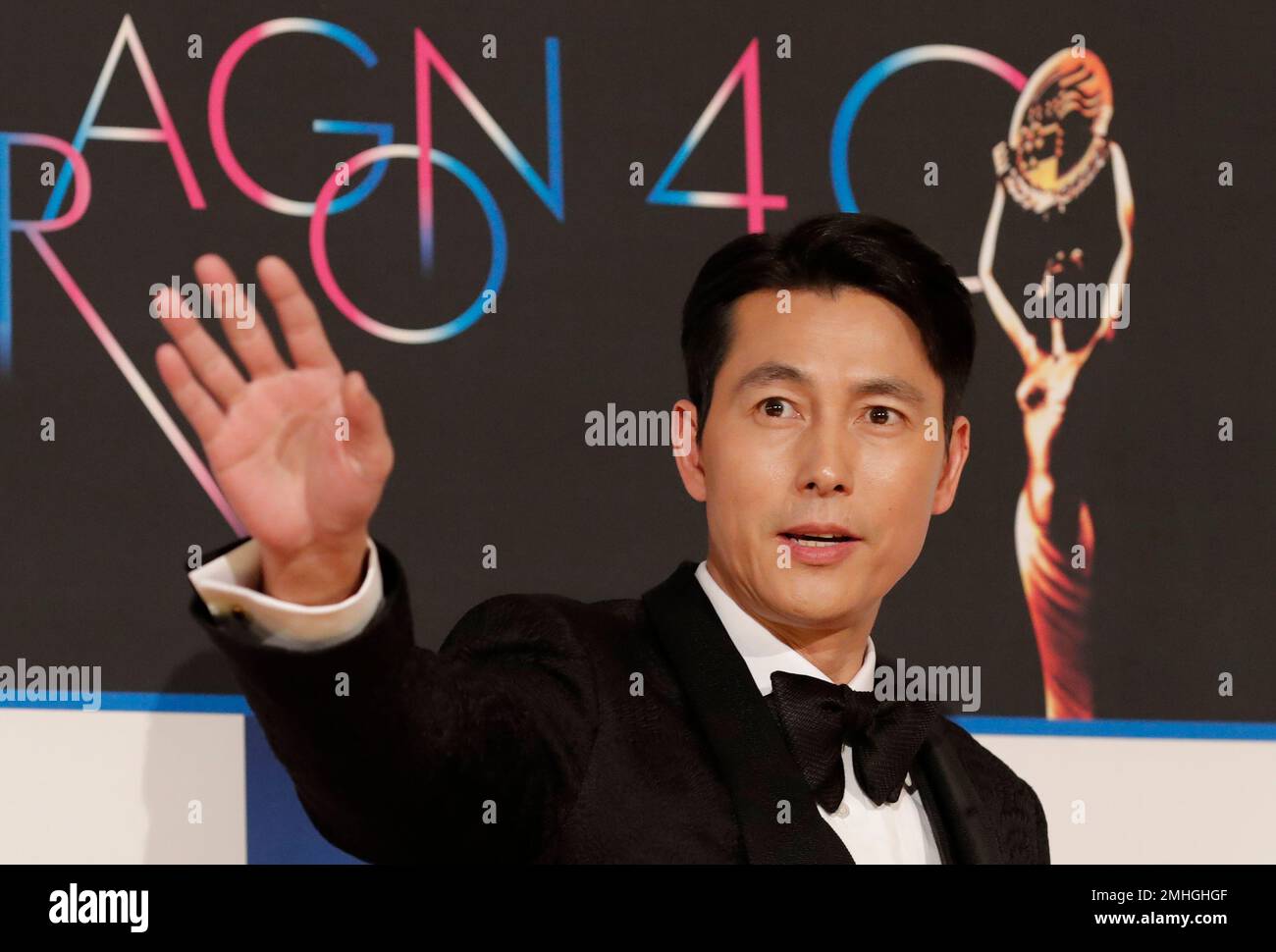 South Korean actor Jung Woo-sung gestures upon his arrival at the 40th ...