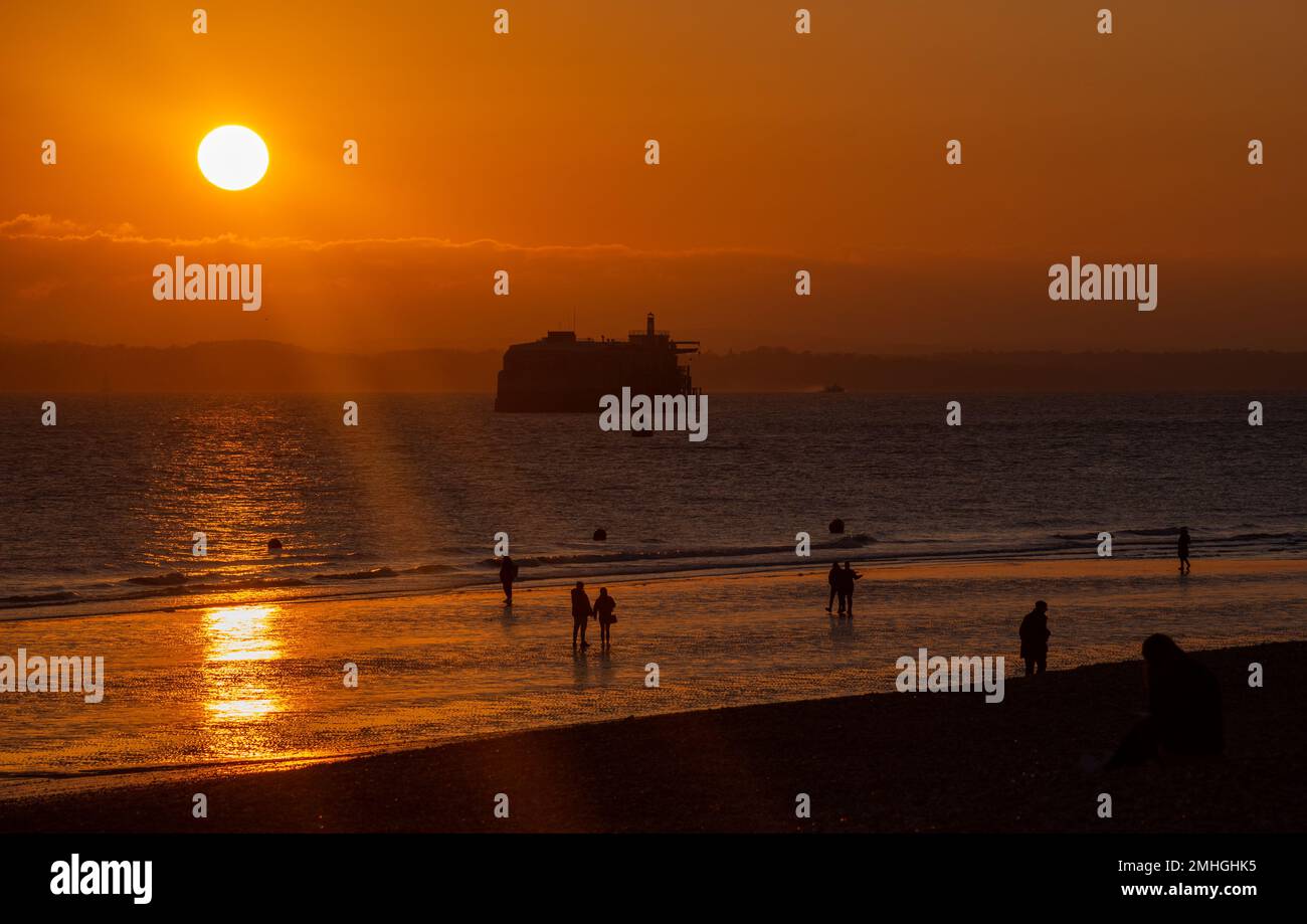 Looking across the Solent at the sun setting over Spitbank fort and the ...